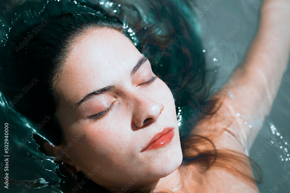 Beautiful girl floating in the sea Stock Photo | Adobe Stock