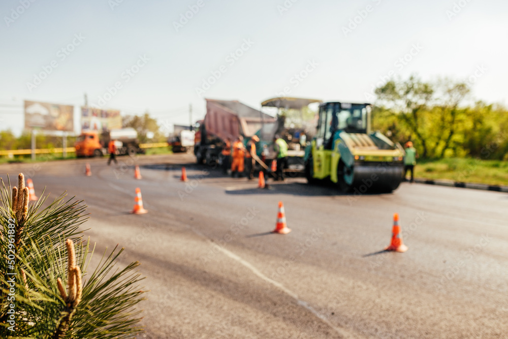 Blur background of construction site is laying new asphalt road ...