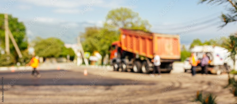 Blur background of construction site is laying new asphalt road ...