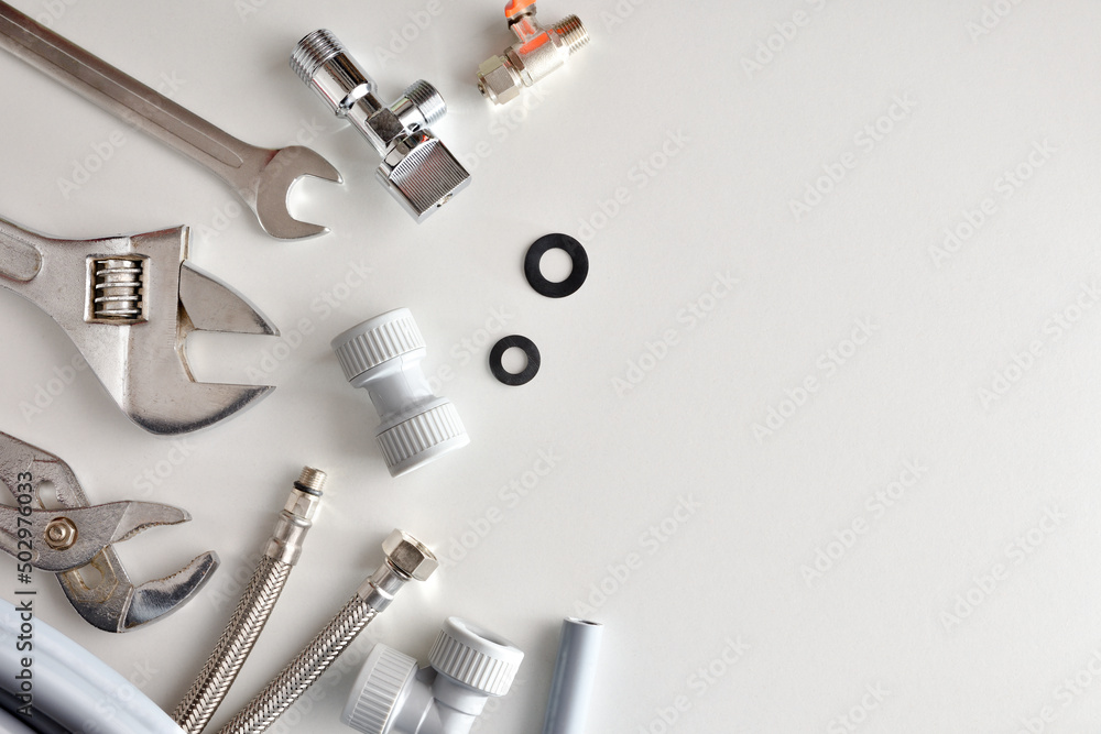 Plumbing background with tools and materials on white table Stock Photo ...