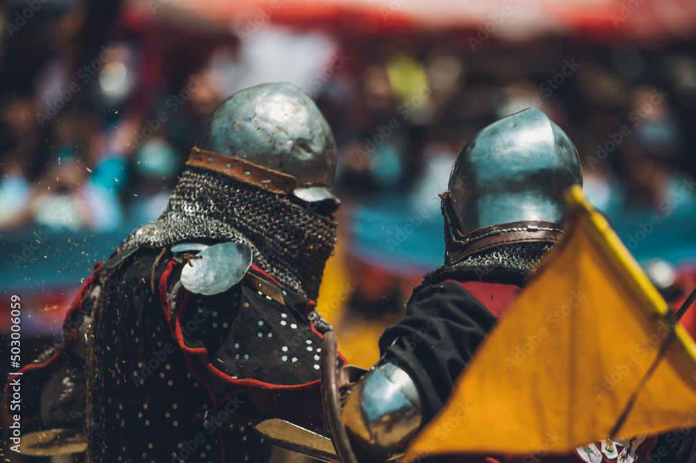 Pitch battle of medieval knights, using metal armor, axes, swords and ...