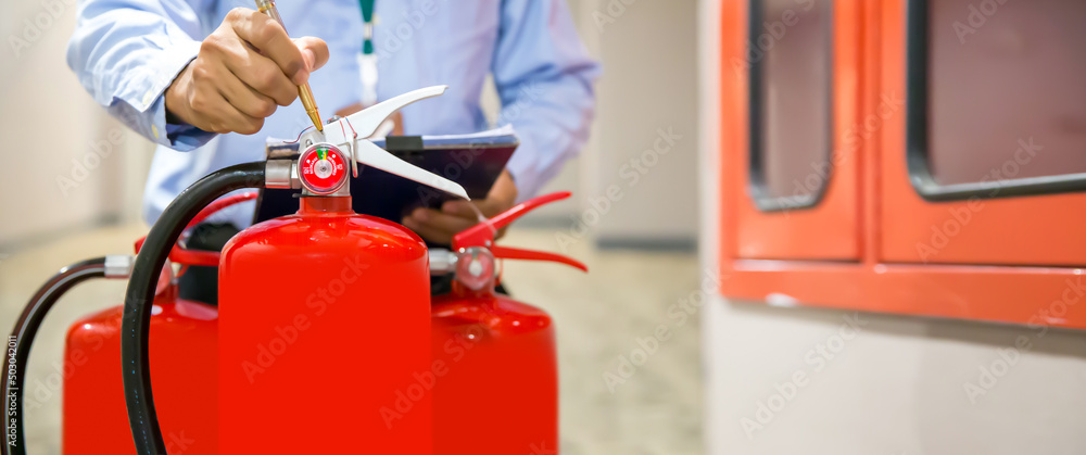 Fire extinguisher has engineer inspection checking pressure gauges of ...