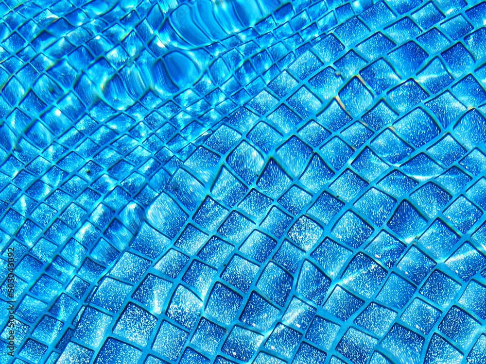 Overhead view of ripple surface water in blue swimming pool with many ...