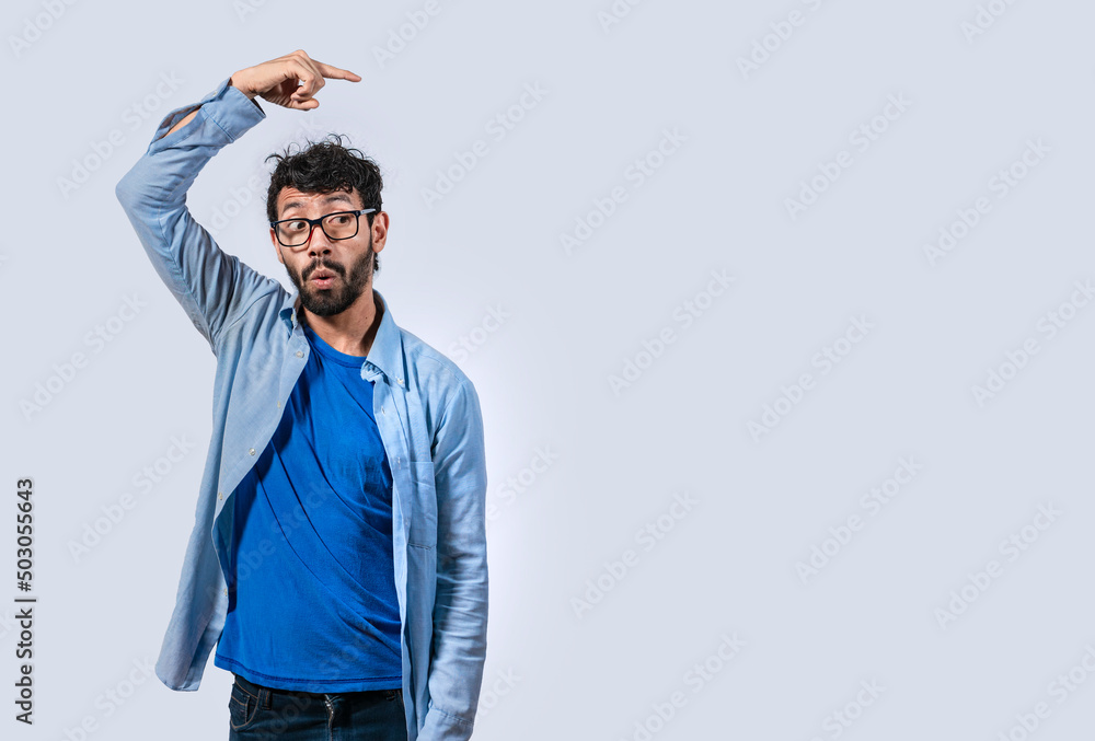 Surprised handsome man pointing to the side, Concept of latin man ...