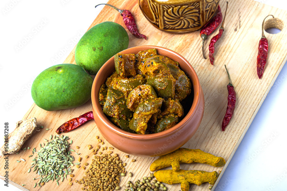 Mango Pickle setup with jar on wooden background with green mango ...