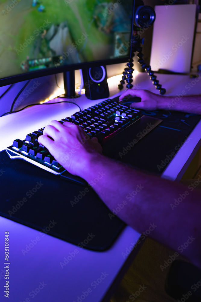Hands of a young gamer playing video games in a gaming setup Stock ...