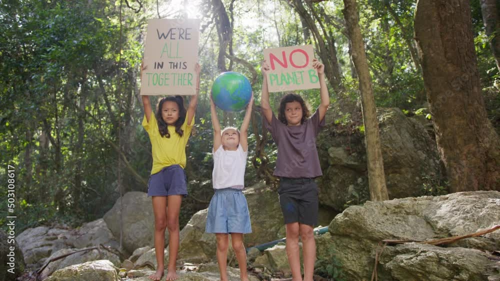 Children protesting and raising the posters and the globe above their ...