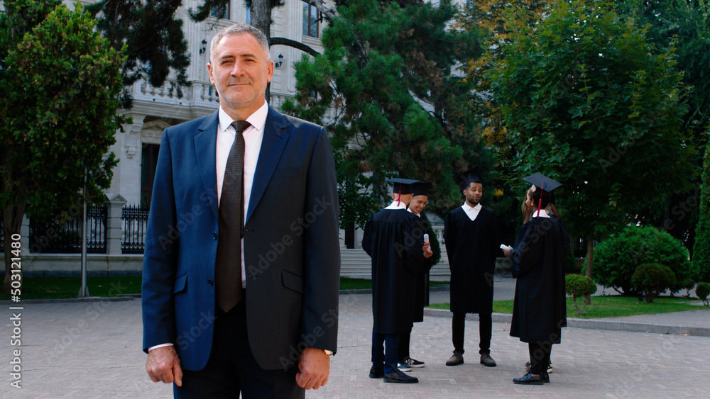 In the college park in the graduation day the principal posing in front ...