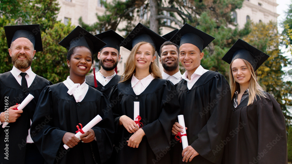 Charismatic and good looking young graduates students closeup to the ...