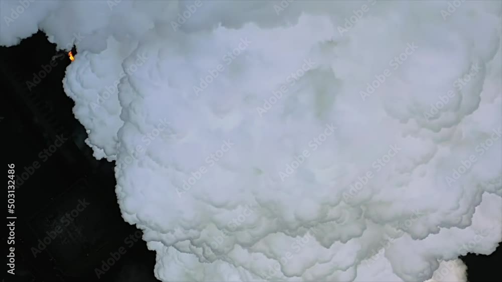 White, dense and thick smoke column, highly polluting from a fire ...
