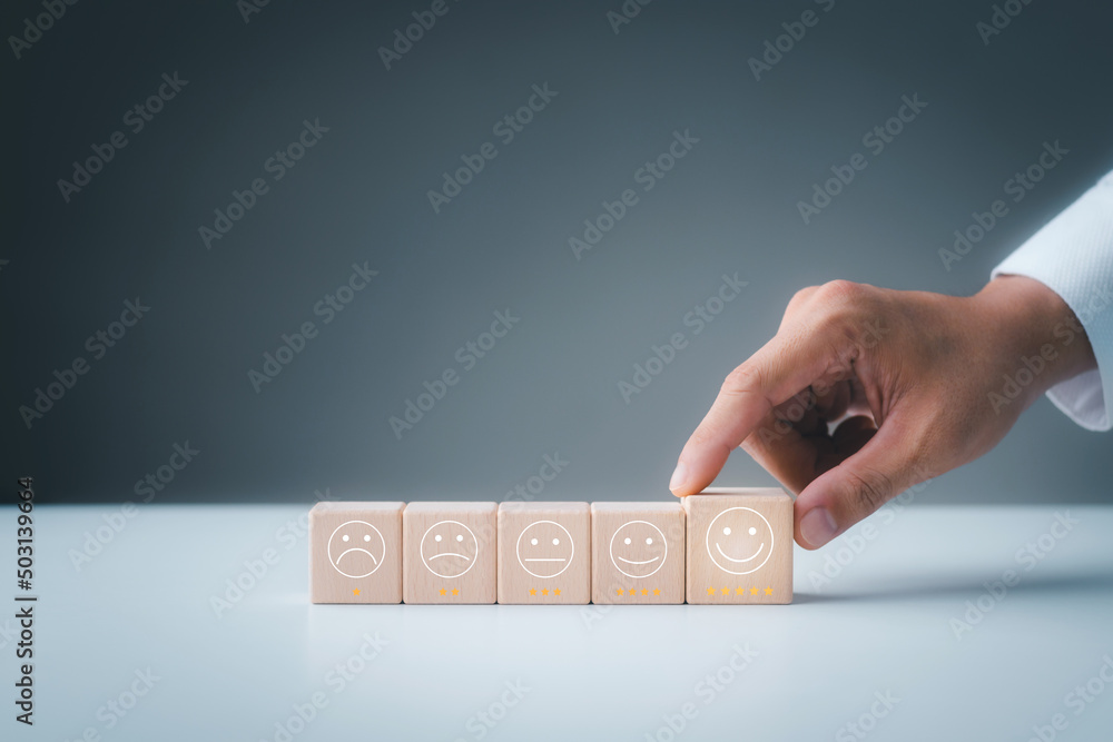 Customer satisfaction survey concept, customer hand selects wooden cube ...