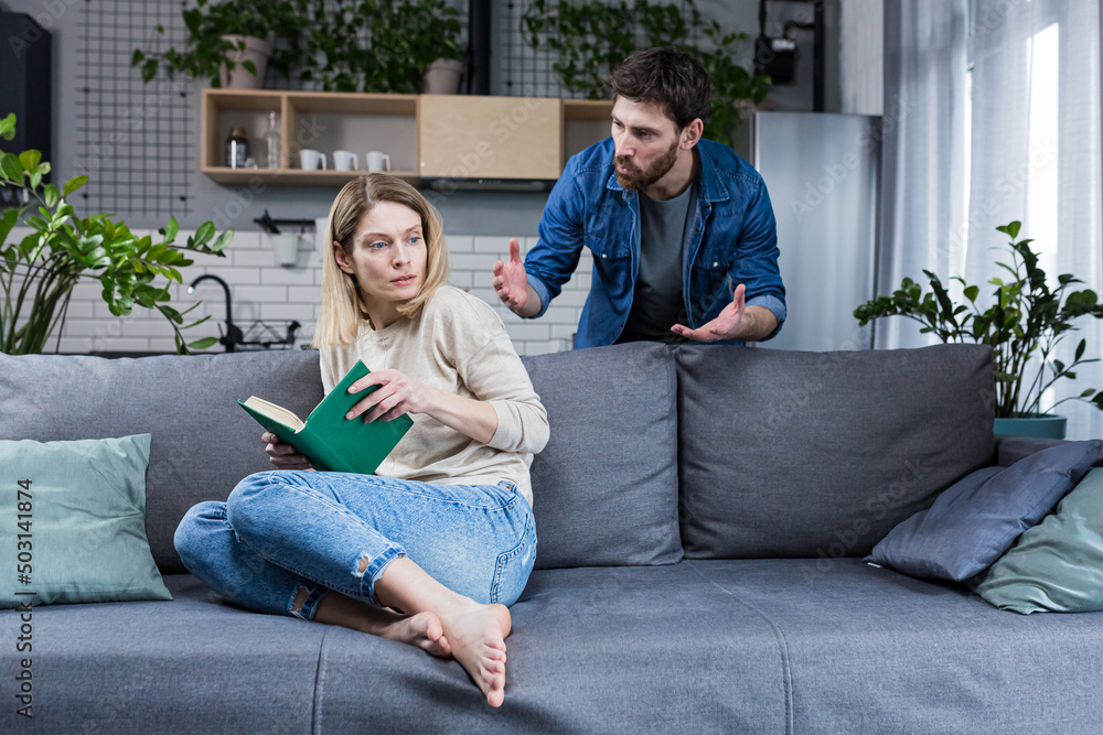 Domestic violence. Family conflict. A man shouts and beats a woman at ...