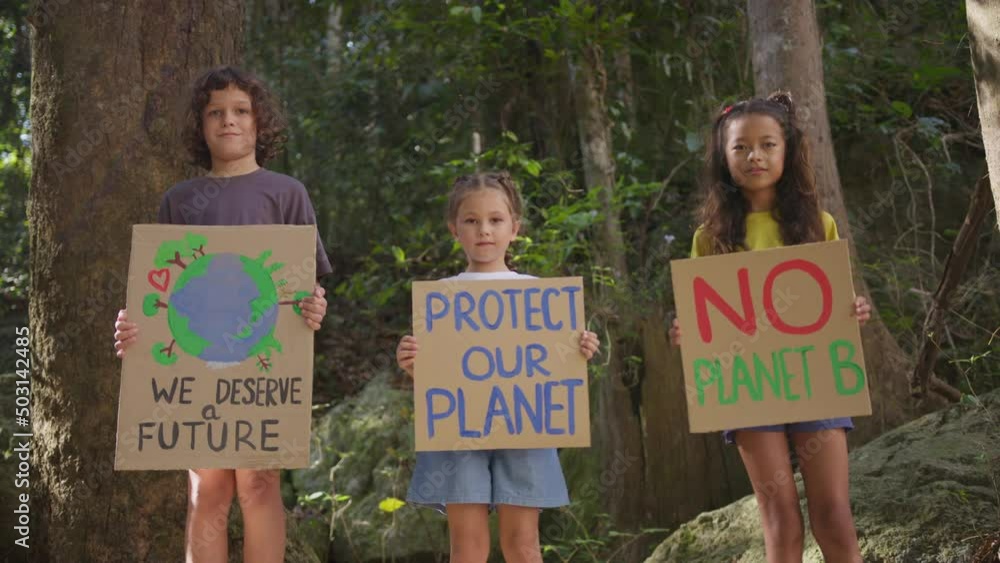 Children at a demonstration in nature with banners in their hands in ...