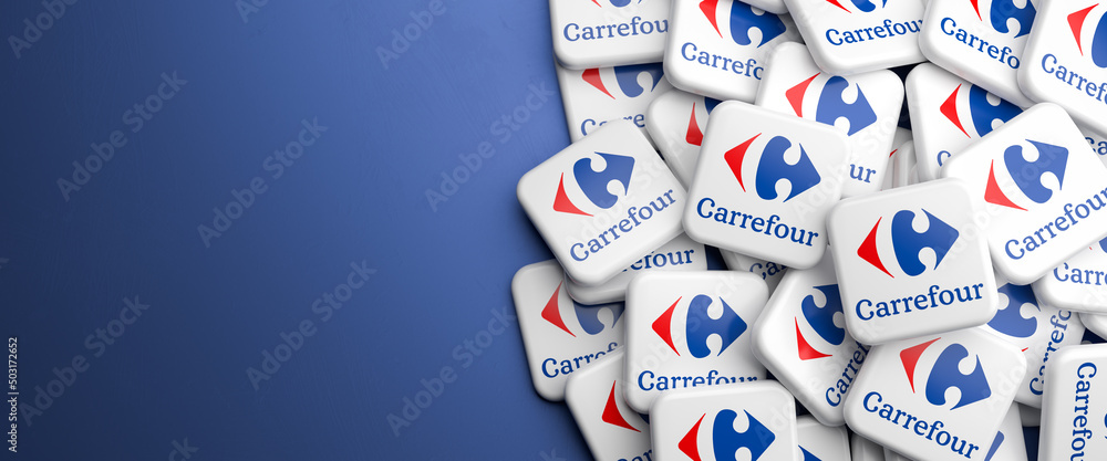 Foto de Logos of the French supermarket chain Carrefour on a heap on a ...