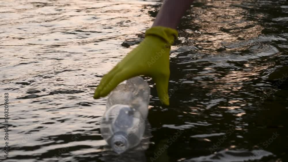 Collecting trash shore garbage. Volunteer cleaning river trash pick up ...