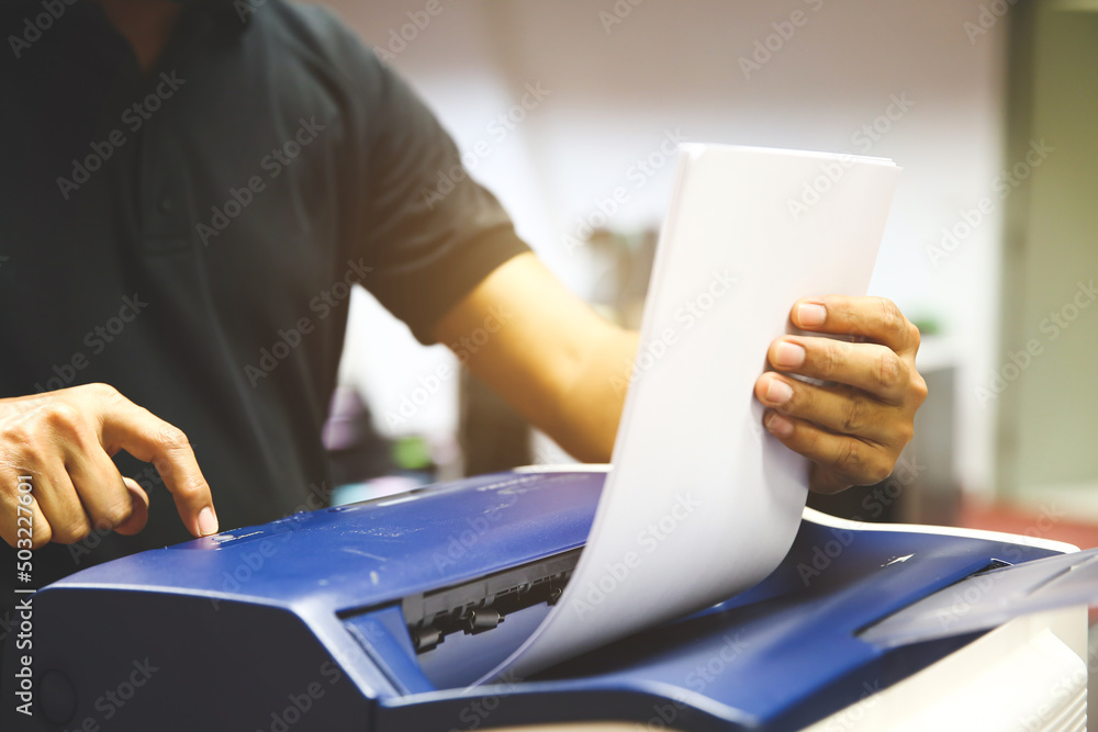 Technician hand press button and load paper in tray to using ...