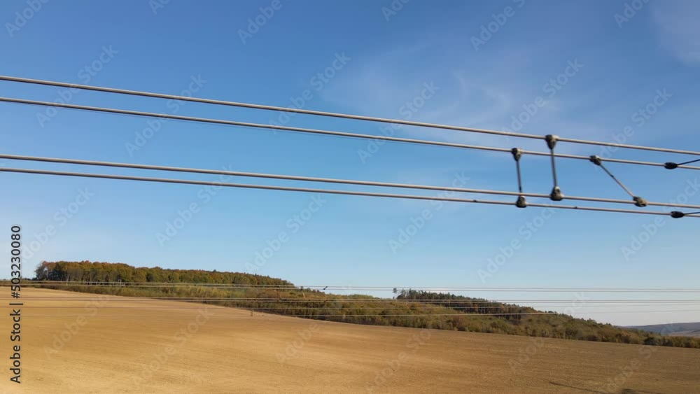 High voltage tower with electric power lines divided by safe guard ...