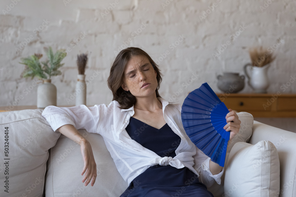 Exhausted overheated girl feeling hot at home due to summer weather ...