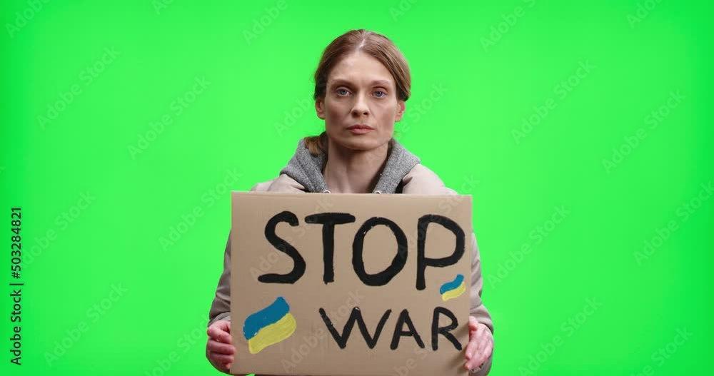 Portrait of upset frustrated female holding card Stop War protesting ...