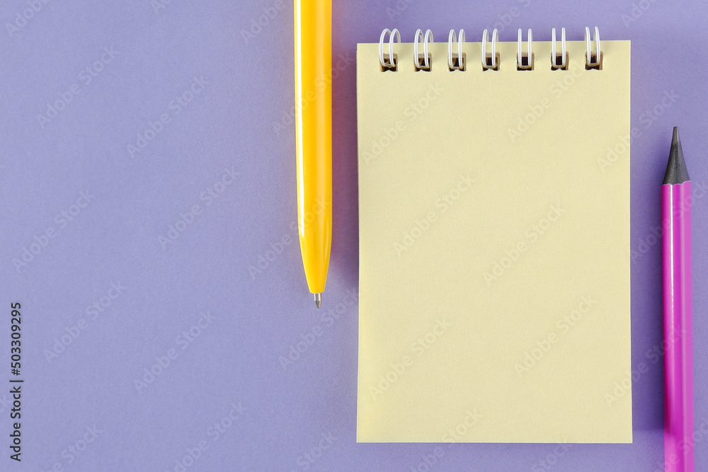 On a purple background - a sketchbook or notebook sewn with a spring ...