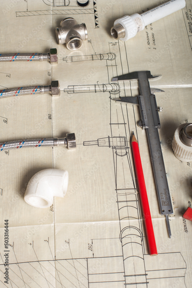 Drawing up a plumbing repair plan with spare parts and tools on ...