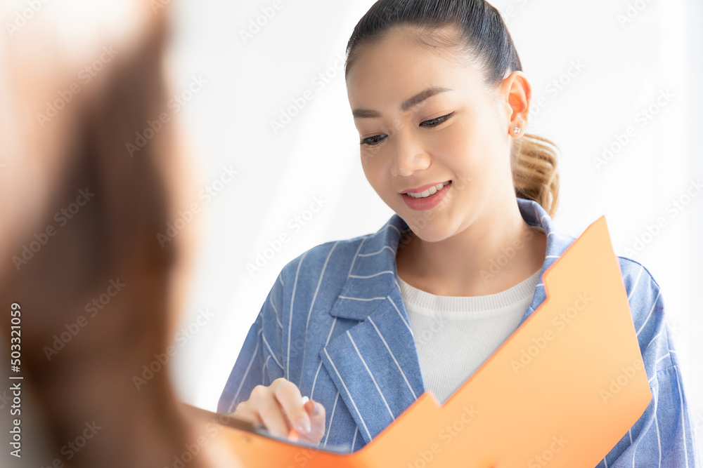 Beautiful young asian woman is interviewing for a job. Her interviewers ...