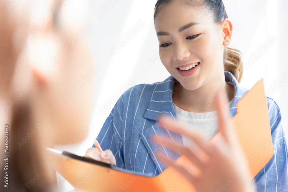 Foto de Beautiful young asian woman is interviewing for a job. Her ...