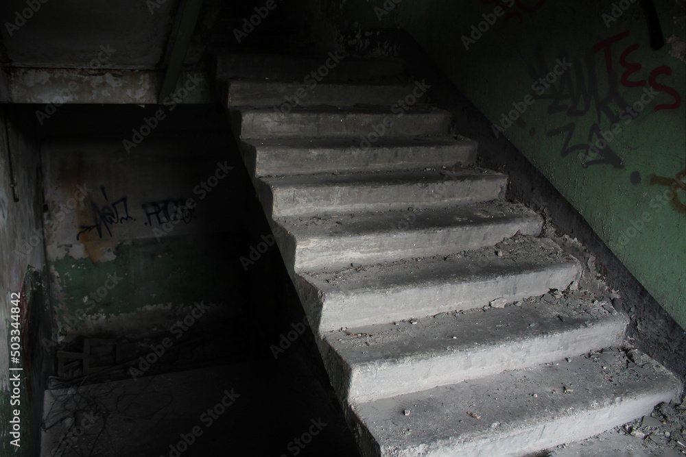 Stairs inside old abandoned building. Shabby paint and tattered walls ...