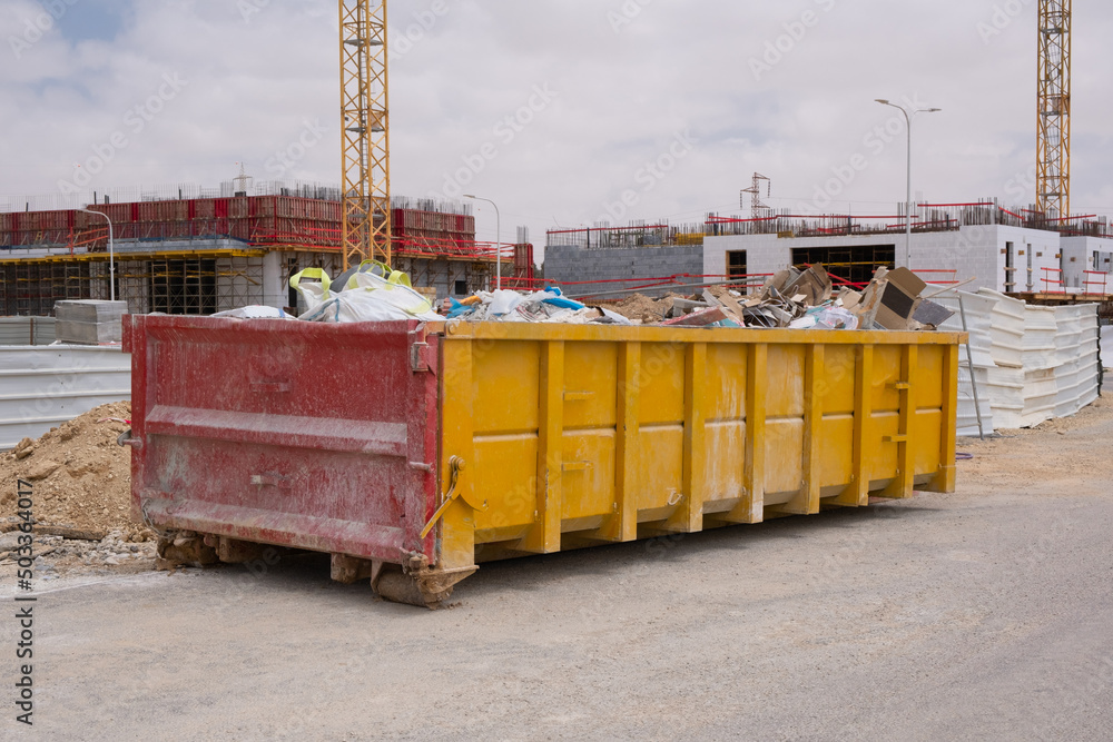 Construction waste in a Huge Overloaded dumpster. Waste metal tank ...