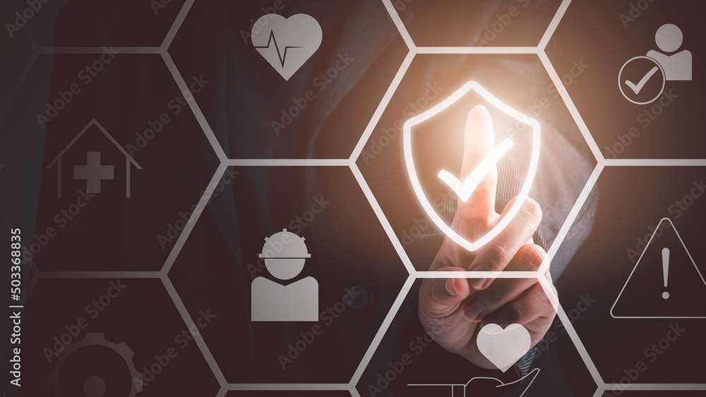 Work safety concept. Businessman touching check mark in shield icon ...