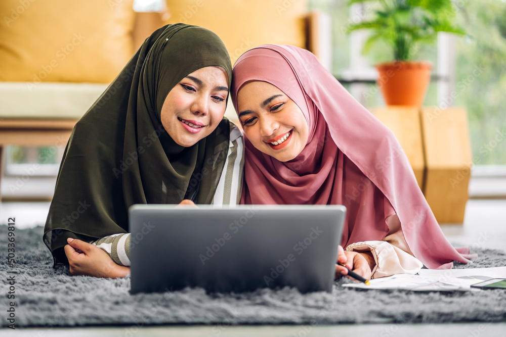 Stockfoto Young two smiling happy beautiful asian muslim woman relaxing ...