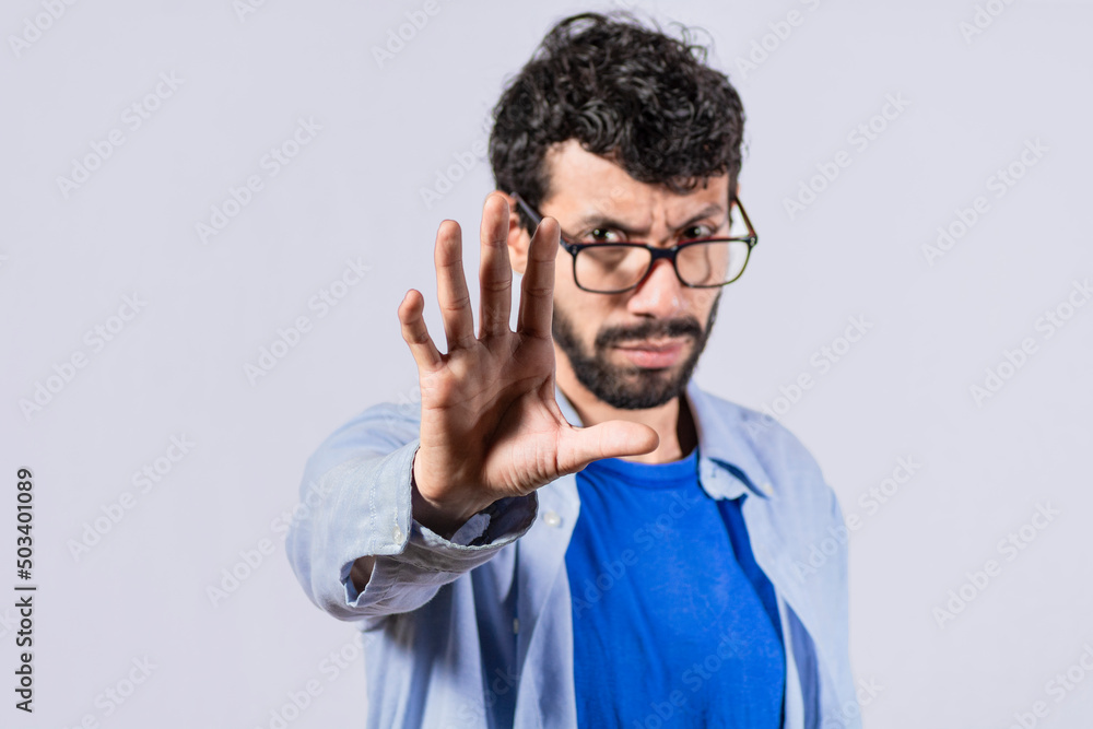 Serious young man stop sign with palm, caucasian man stop sign with ...