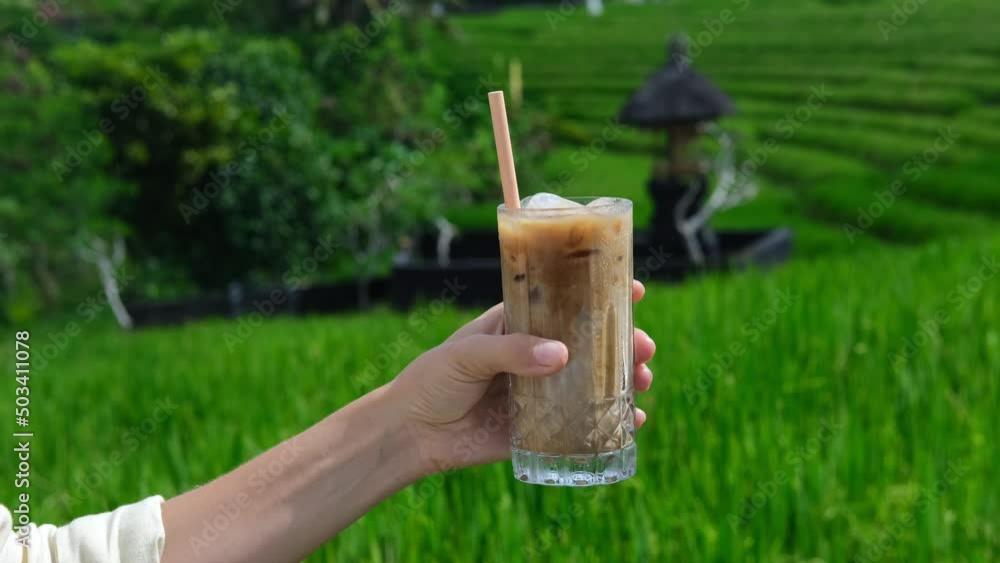 Video „Iced coffee in a glass with a straw. On rice terrace indonesia ...