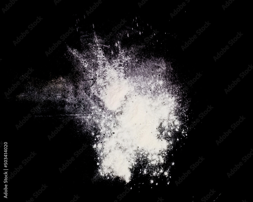 Powder explosion isolated on Dark background. dust particles splash ...