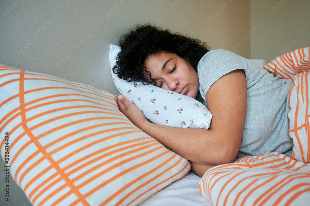 Young woman sleeping on bed at home Stock Photo | Adobe Stock