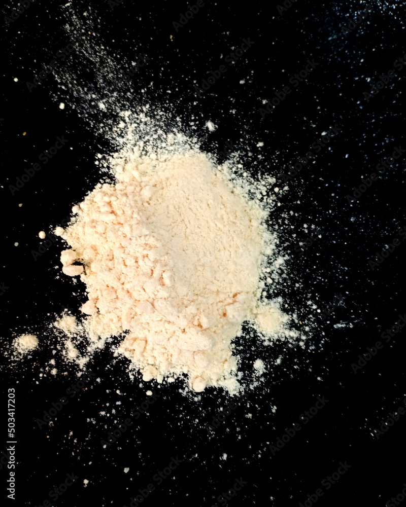 White powder explosion isolated on Dark background. White dust ...