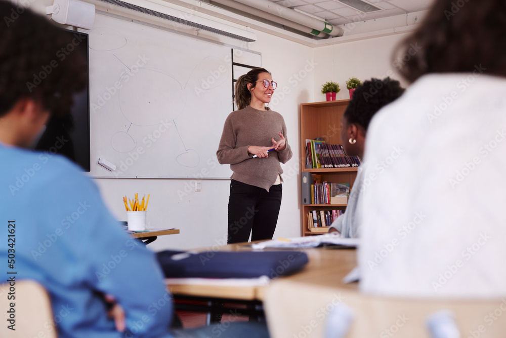 Female teacher in classroom Stock Photo | Adobe Stock