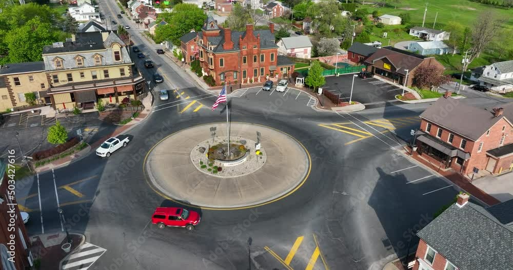 American flag proudly waves in small town. Rural historic community on ...