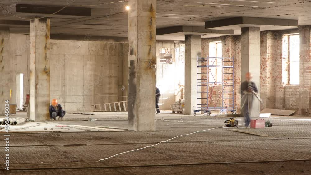 Construction workers with scaffolding and tools inside the floor of ...