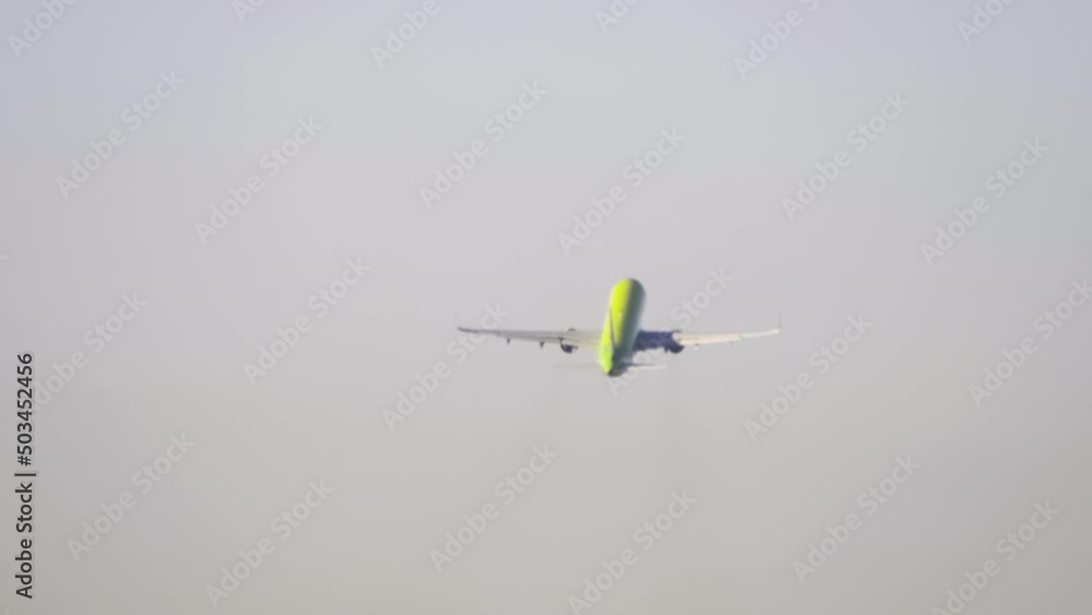 Passenger airplane takes off, departure. Rear view, the jet plane is ...