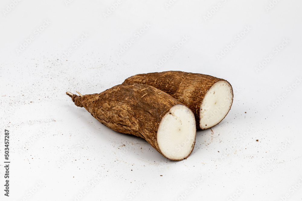 Tapioca / Kappa - roots of the cassava plant, cut and whole isolated in ...