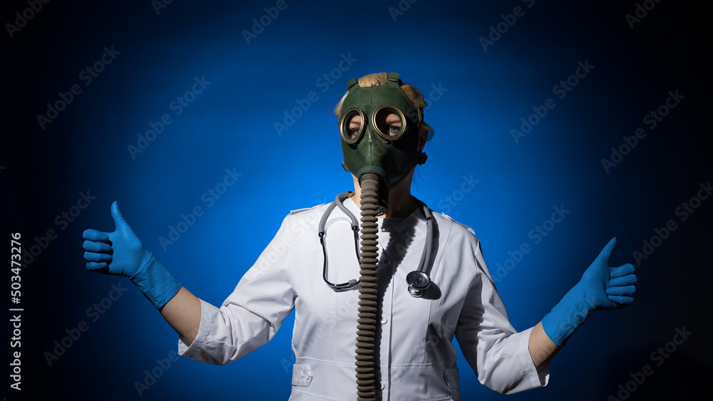 doctor woman in gas mask and gloves shows two thumbs up on blue ...