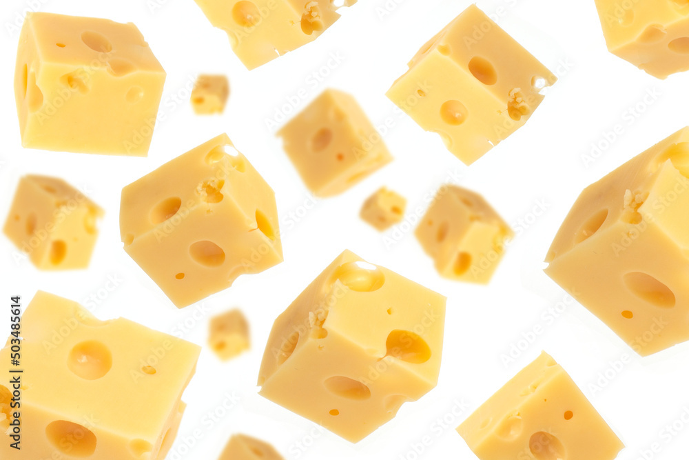 Falling cheese cubes, isolated on white background, selective focus ...