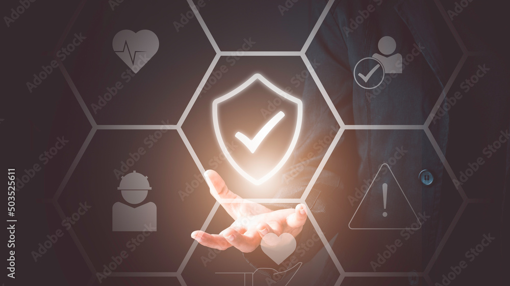 Work safety concept. Businessman holding check mark in shield icon ...