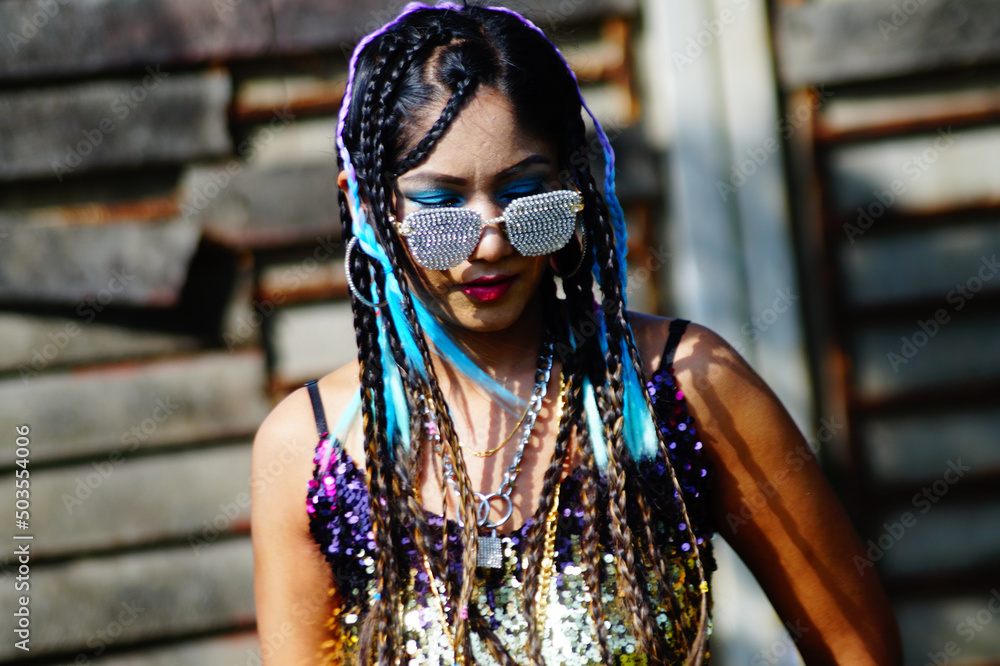Stylish Indian female with dreadlocks and sunglasses posing at camera ...