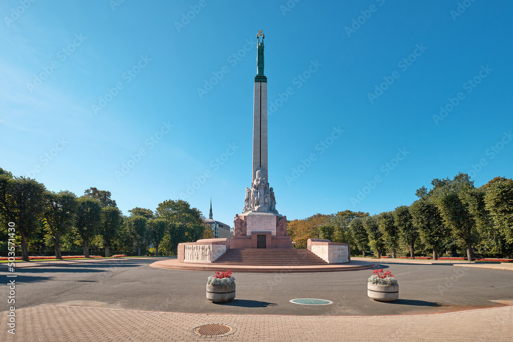 Monument of freedom in Riga, Latvia. Woman holding three gold stars ...