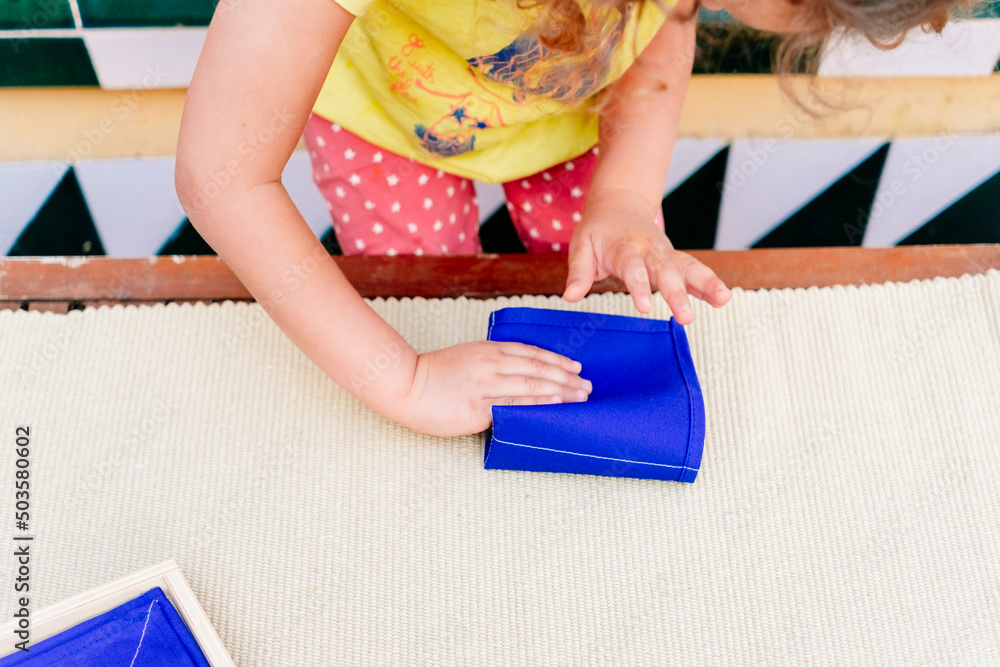 Folding napkins for children is a task to improve the fine motor skills ...