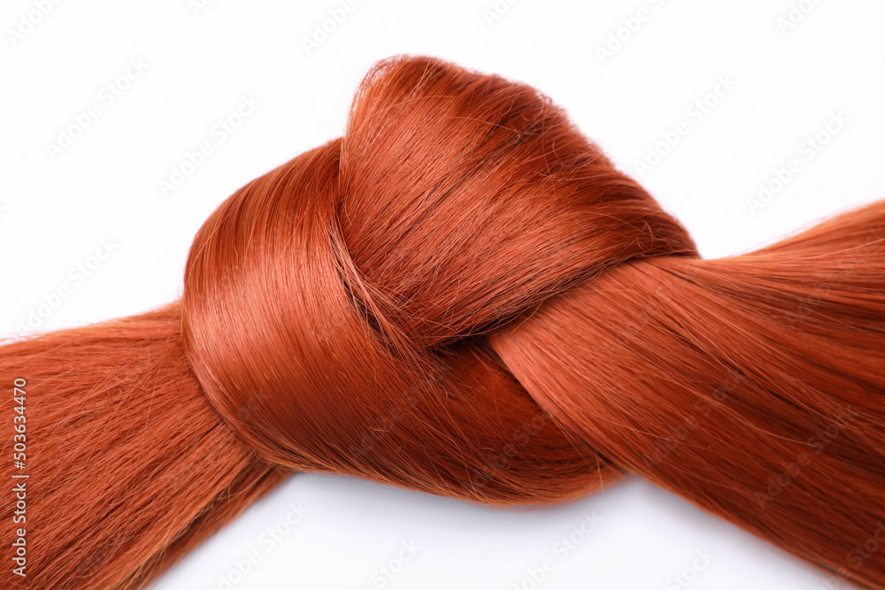 Beautiful strand of red hair tied in knot on white background, top view ...
