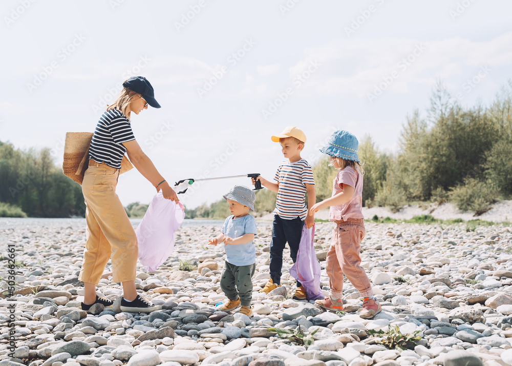 Volunteers family collecting plastic waste trash on river beach. People ...