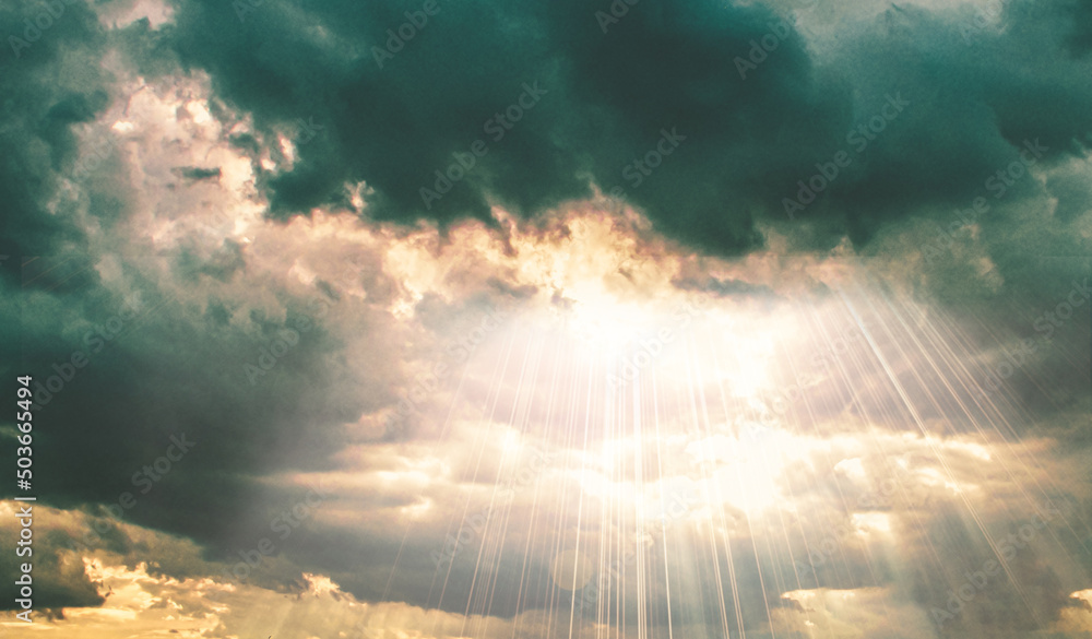 Sun beams shining through dark clouds. Beam of light through the clouds ...